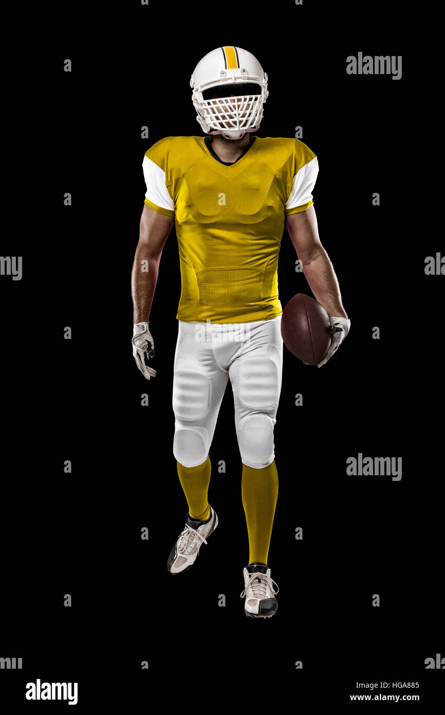 Football Player with a yellow uniform on a black background Stock Photo ...