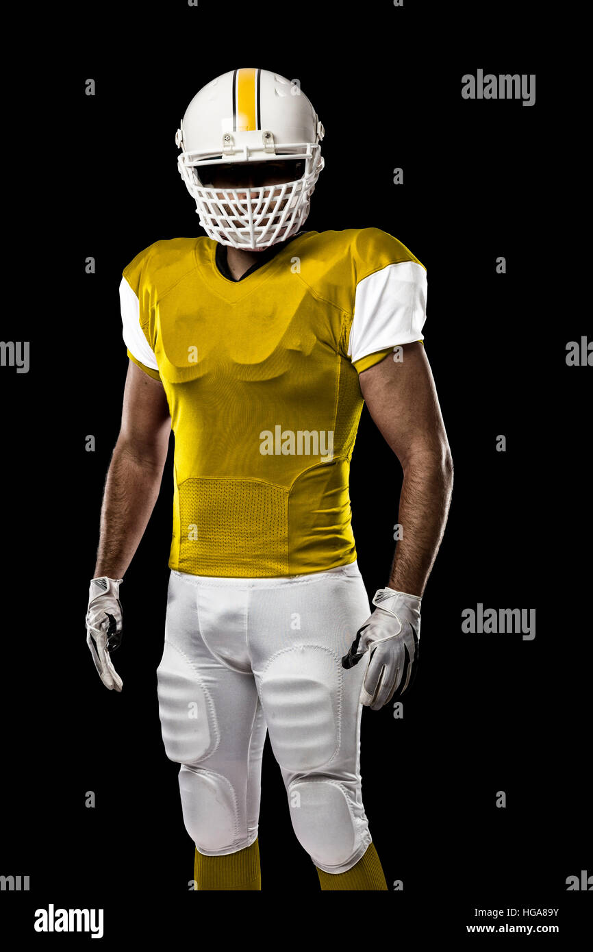 Football Player with a yellow uniform on a black background Stock Photo ...