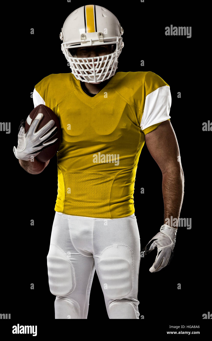 Football Player with a yellow uniform on a black background Stock Photo ...