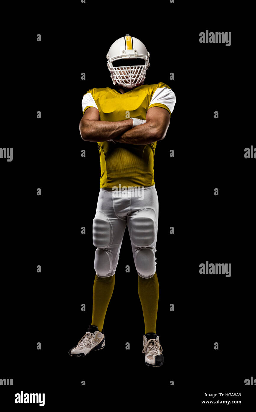 Football Player with a yellow uniform on a black background Stock Photo ...