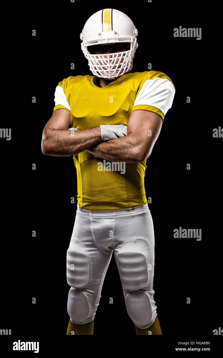 Football Player with a yellow uniform on a black background Stock Photo ...