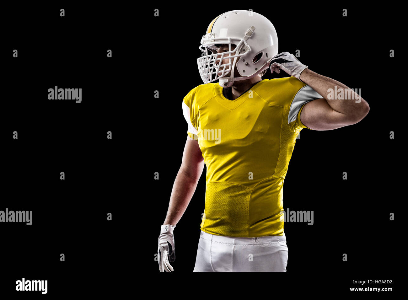 Football Player with a yellow uniform on a black background Stock Photo ...