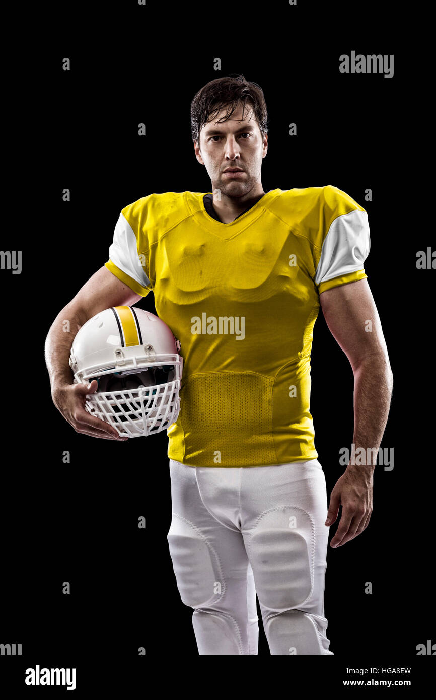 Football Player with a yellow uniform on a black background Stock Photo ...