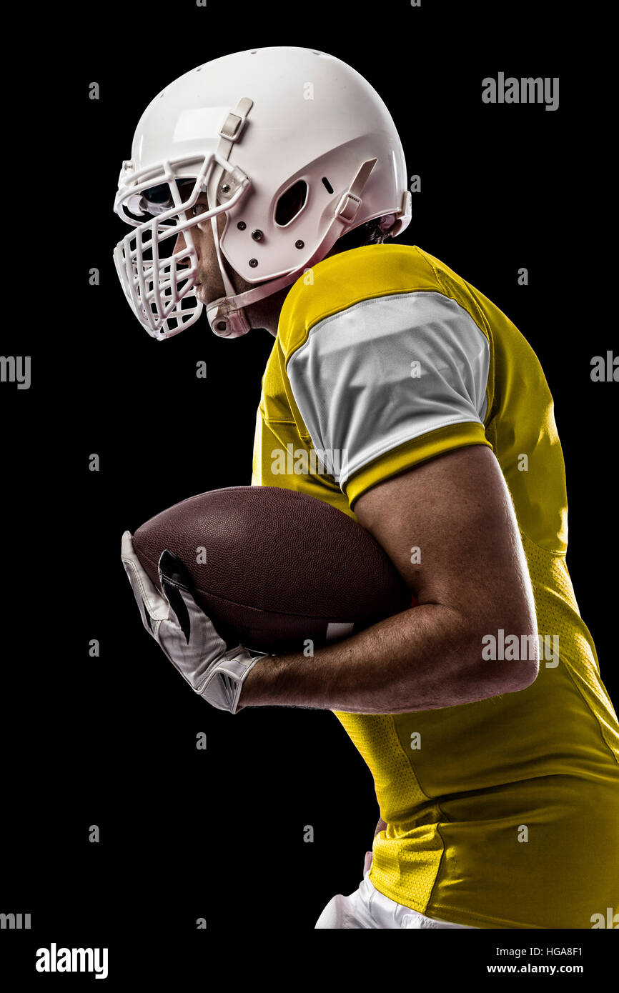 Football Player with a yellow uniform Running on a black background ...