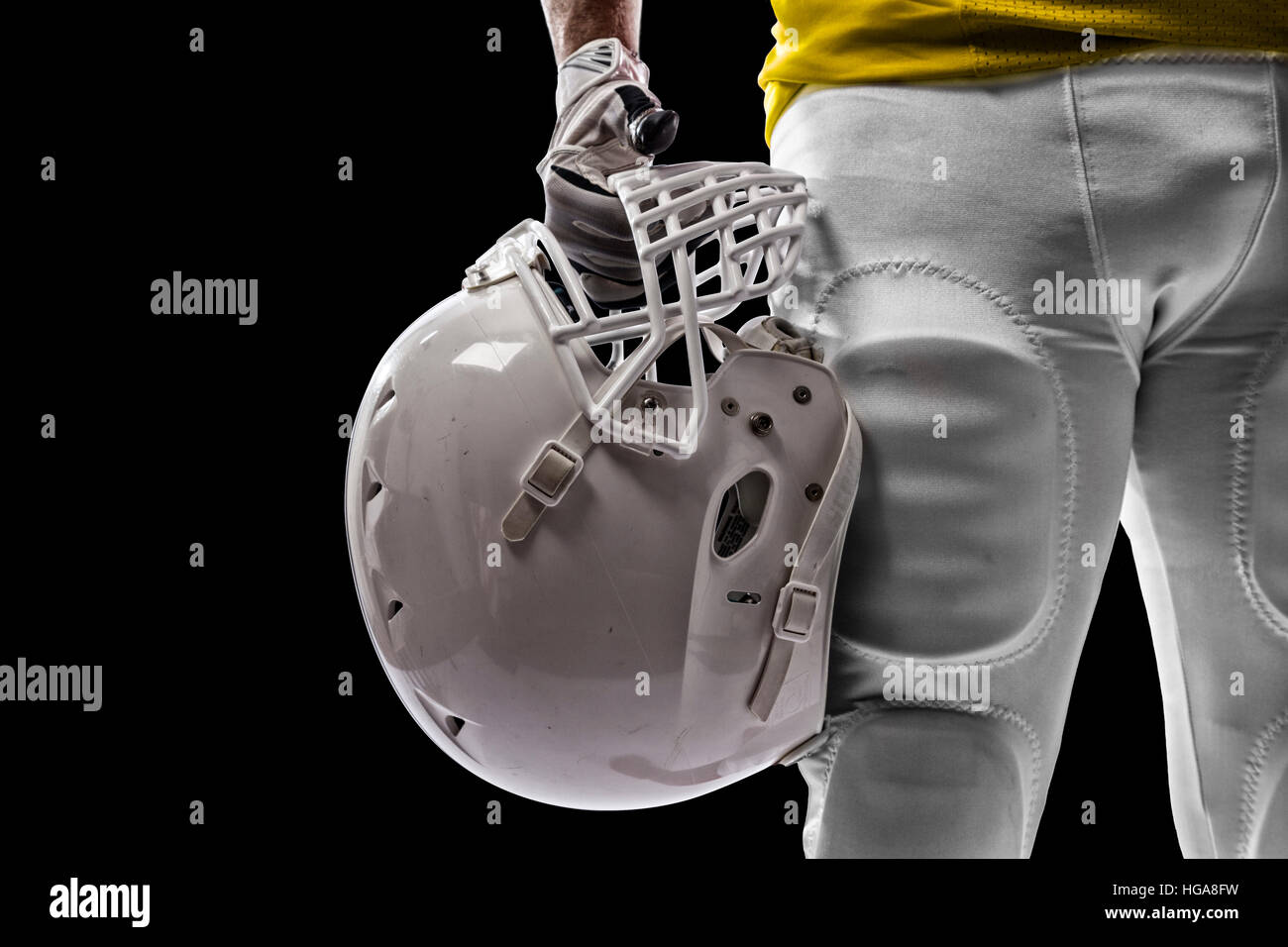 Football Player with a yellow uniform on a black background Stock Photo ...
