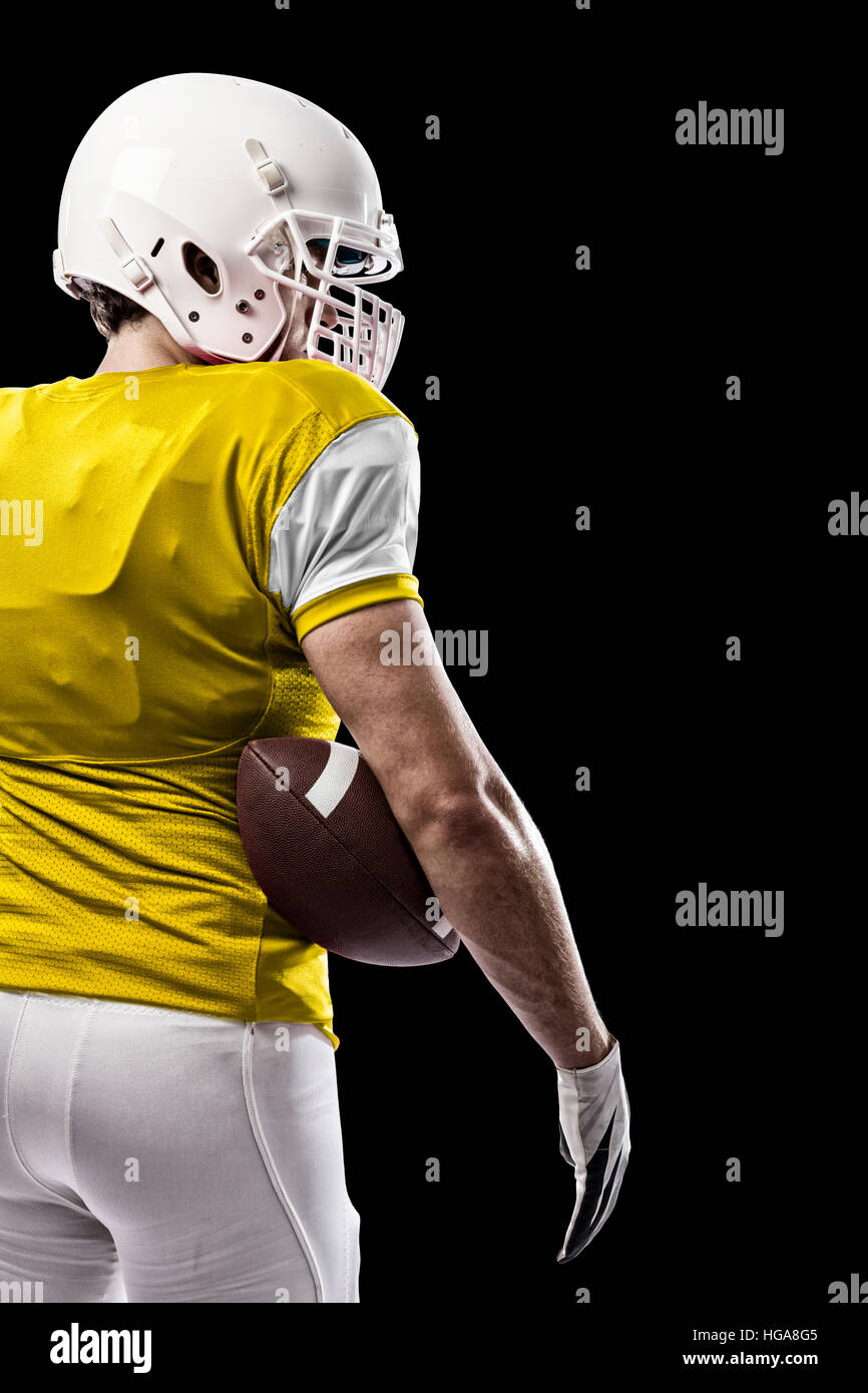 Football Player with a yellow uniform on a black background Stock Photo ...