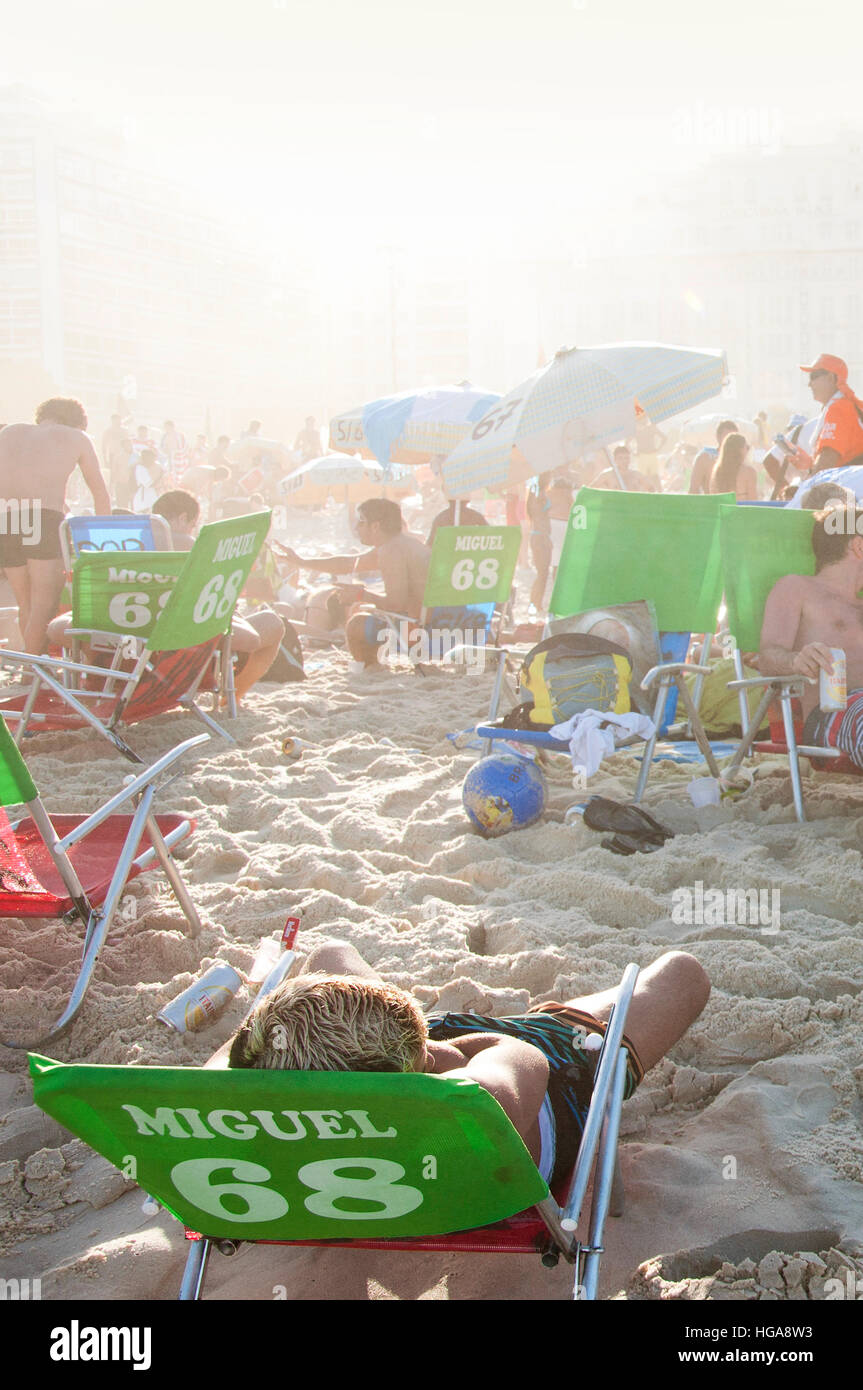 Man napping in a lounge chair on Copacabana beach Stock Photo - Alamy