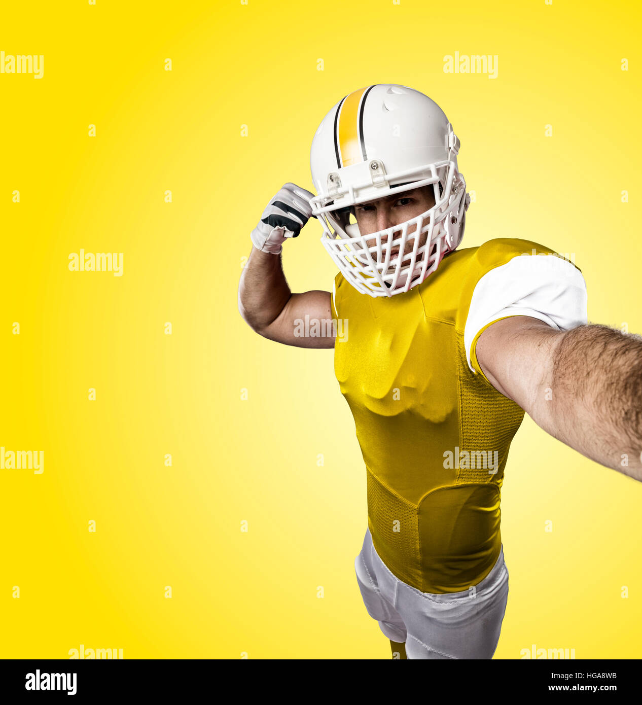 Football Player with a yellow uniform making a selfie on a yellow ...