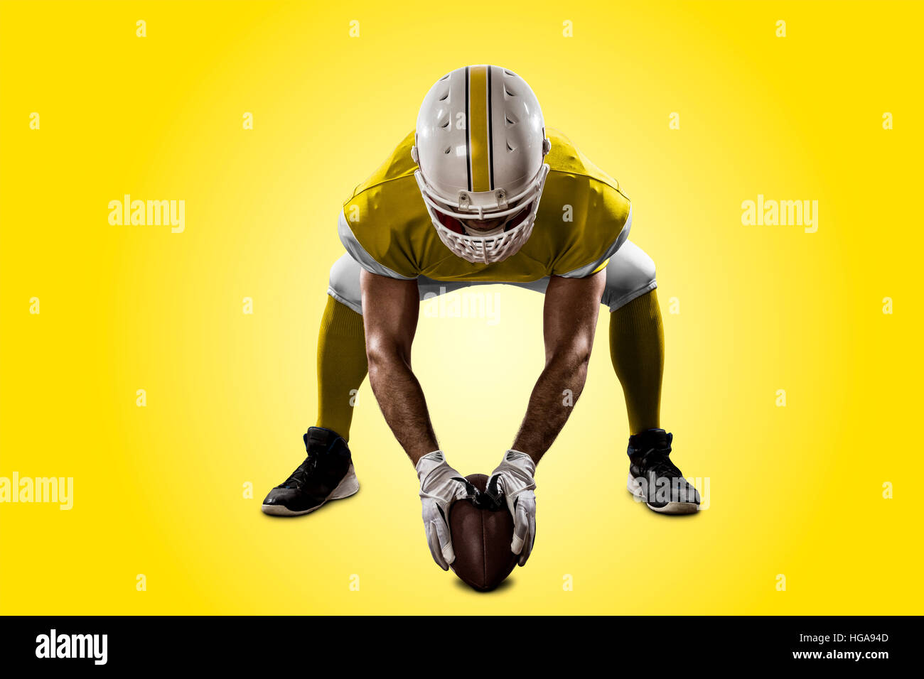 Football Player with a yellow uniform on the scrimmage line, on a ...
