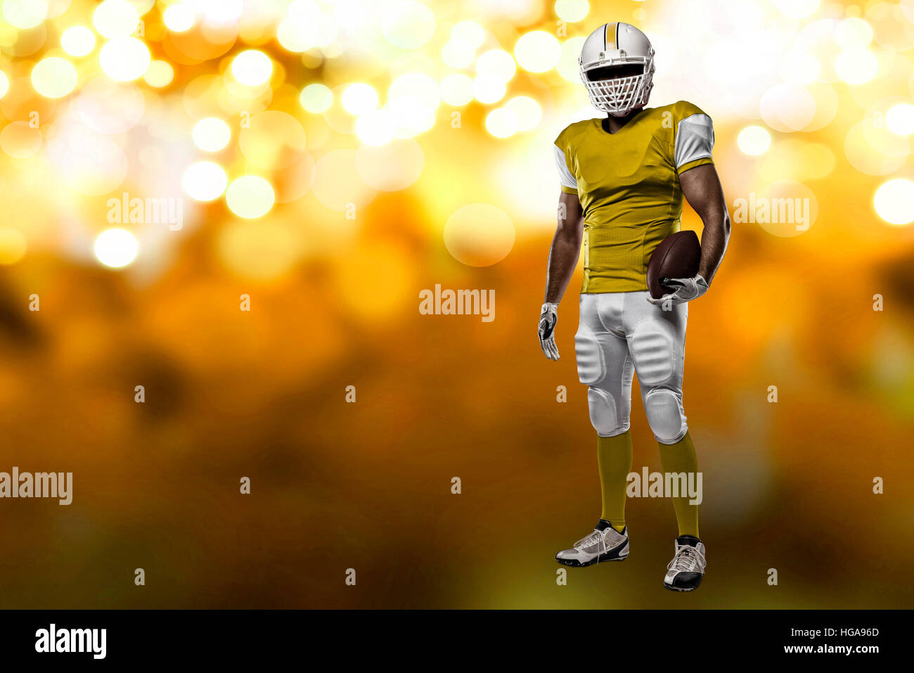 Football Player with a yellow uniform on a yellow lights background ...
