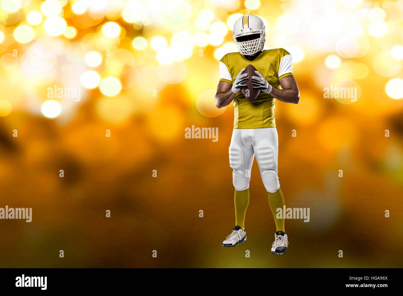 Football Player with a yellow uniform on a yellow lights background ...