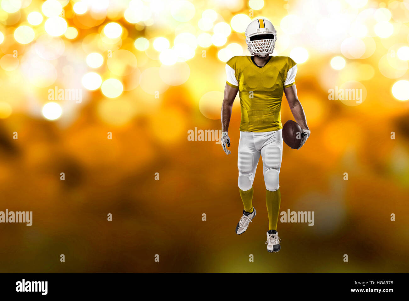 Football Player with a yellow uniform on a yellow lights background ...