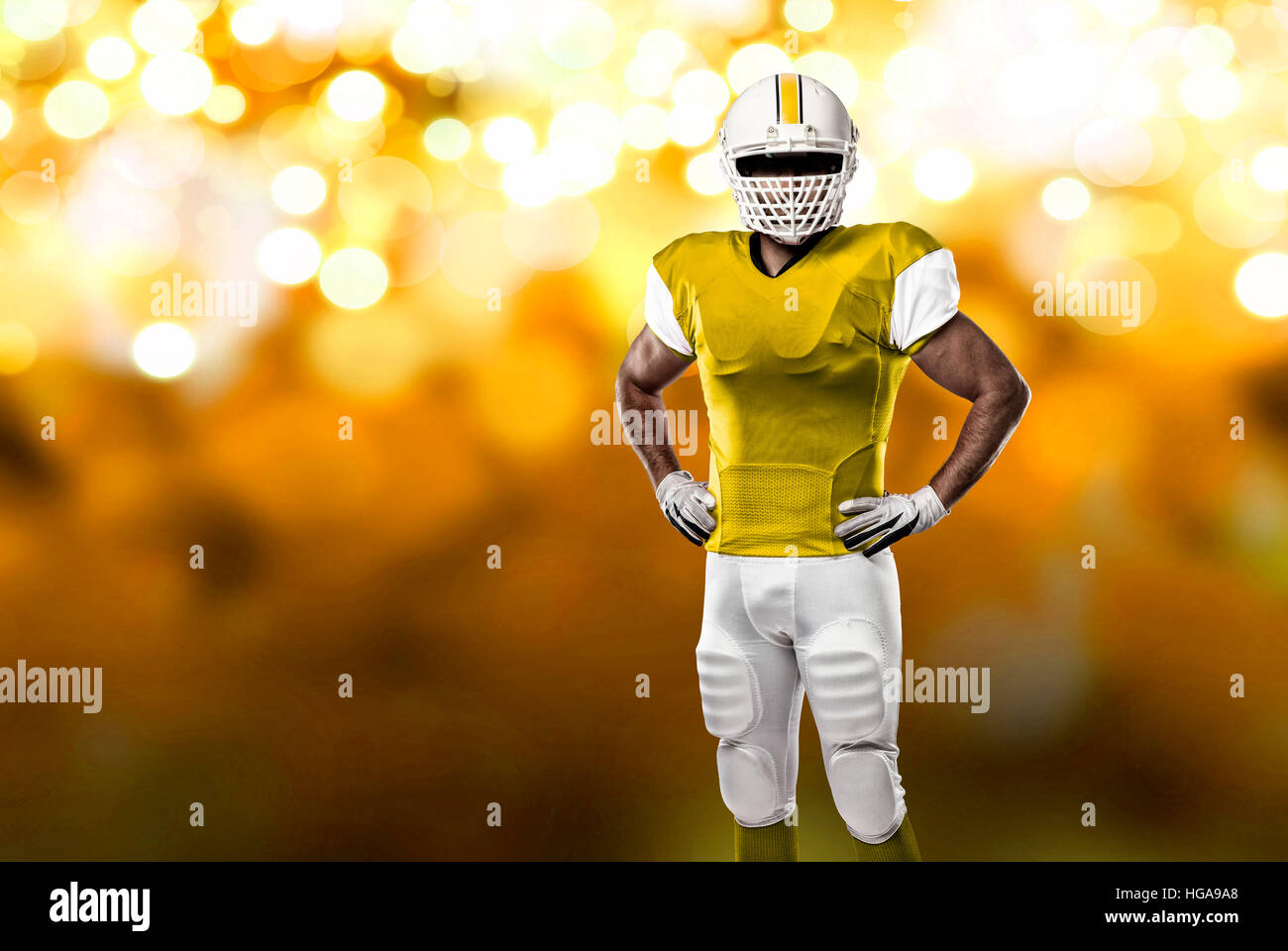 Football Player with a yellow uniform on a yellow lights background ...