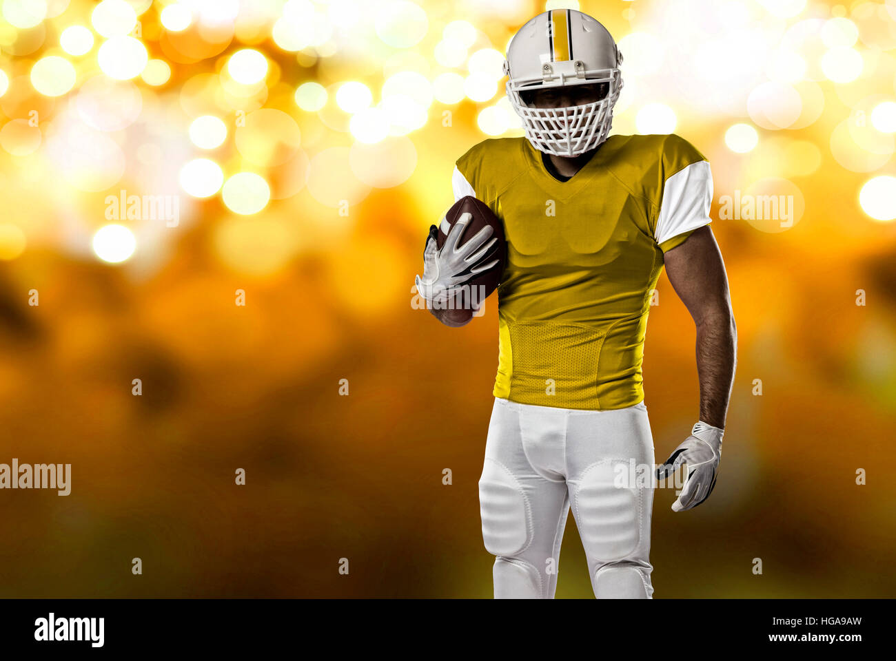 Football Player with a yellow uniform on a yellow lights background ...