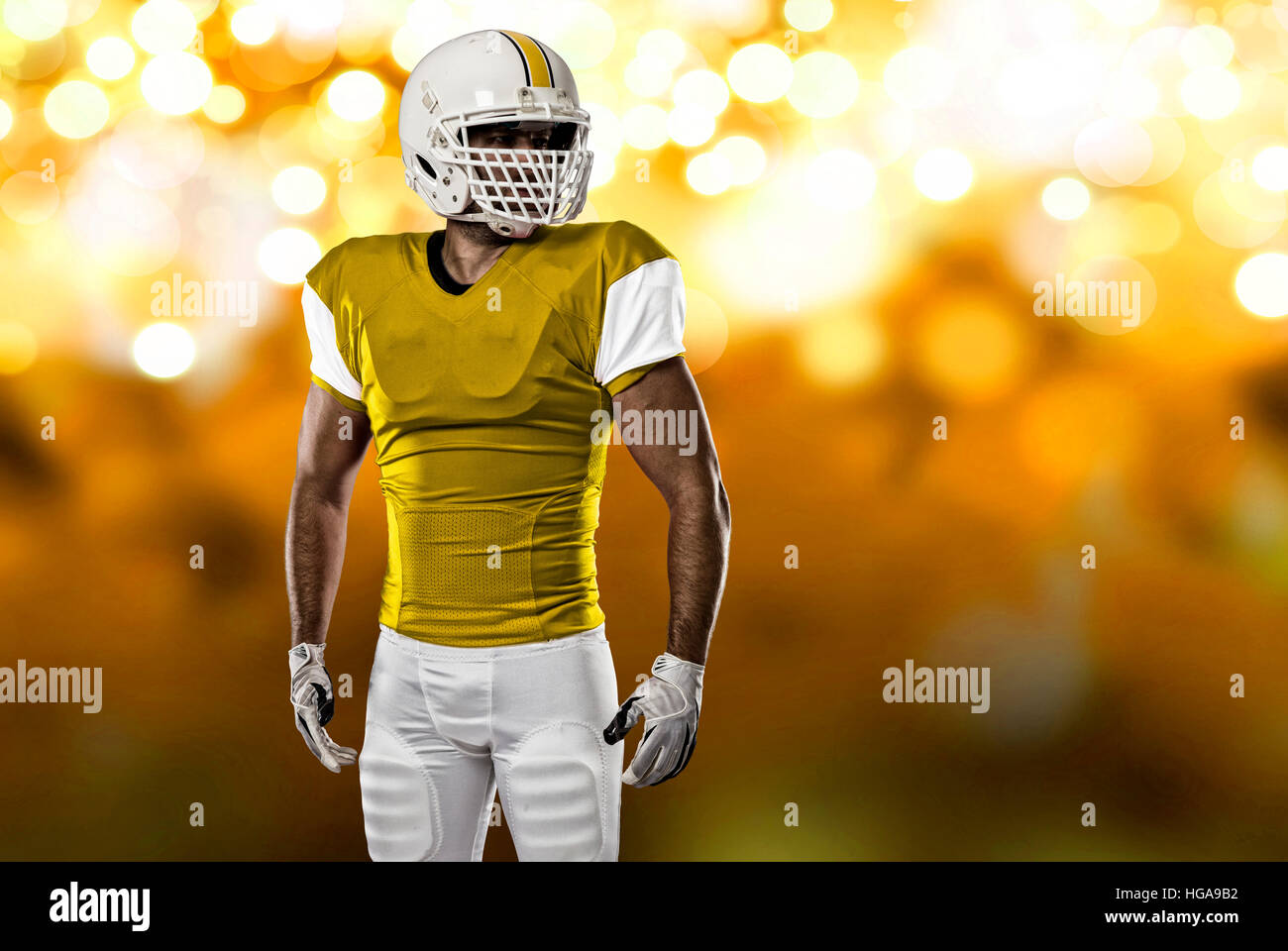 Football Player with a yellow uniform on a yellow lights background ...