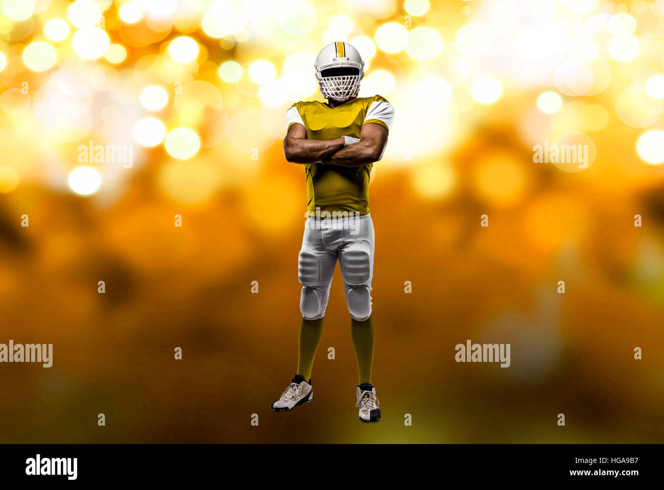 Football Player with a yellow uniform on a yellow lights background ...