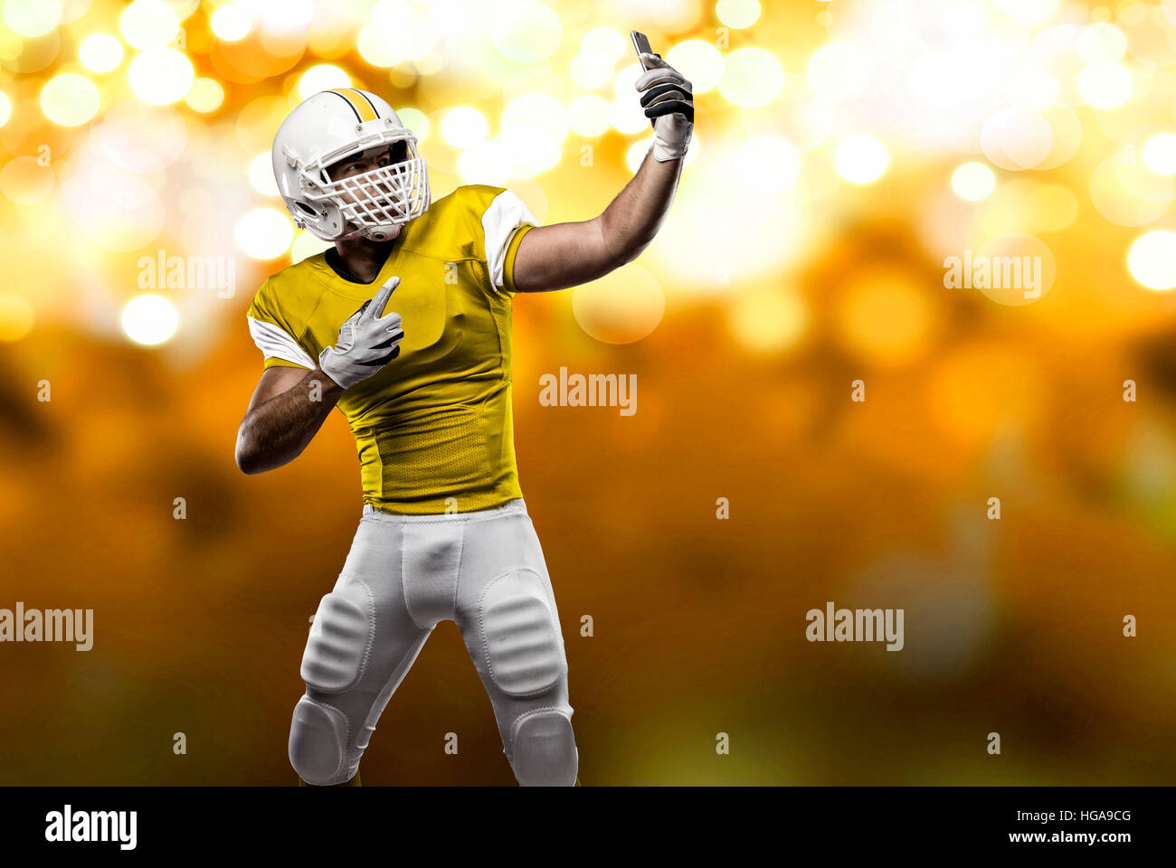 Football Player with a yellow uniform making a selfie on a yellow ...