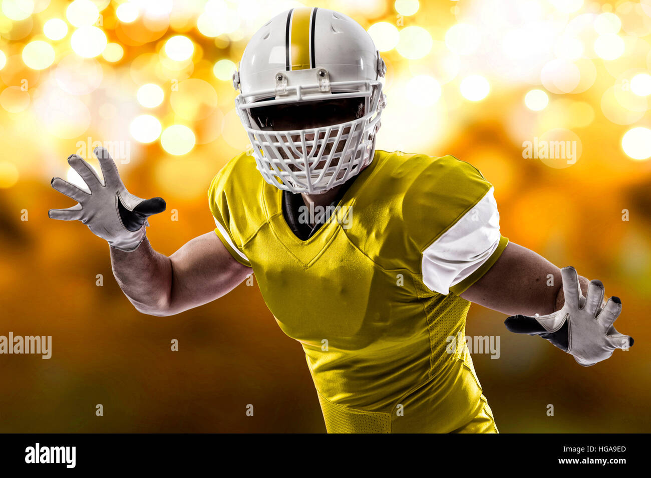 Football Player with a yellow uniform making a tackle on a yellow ...