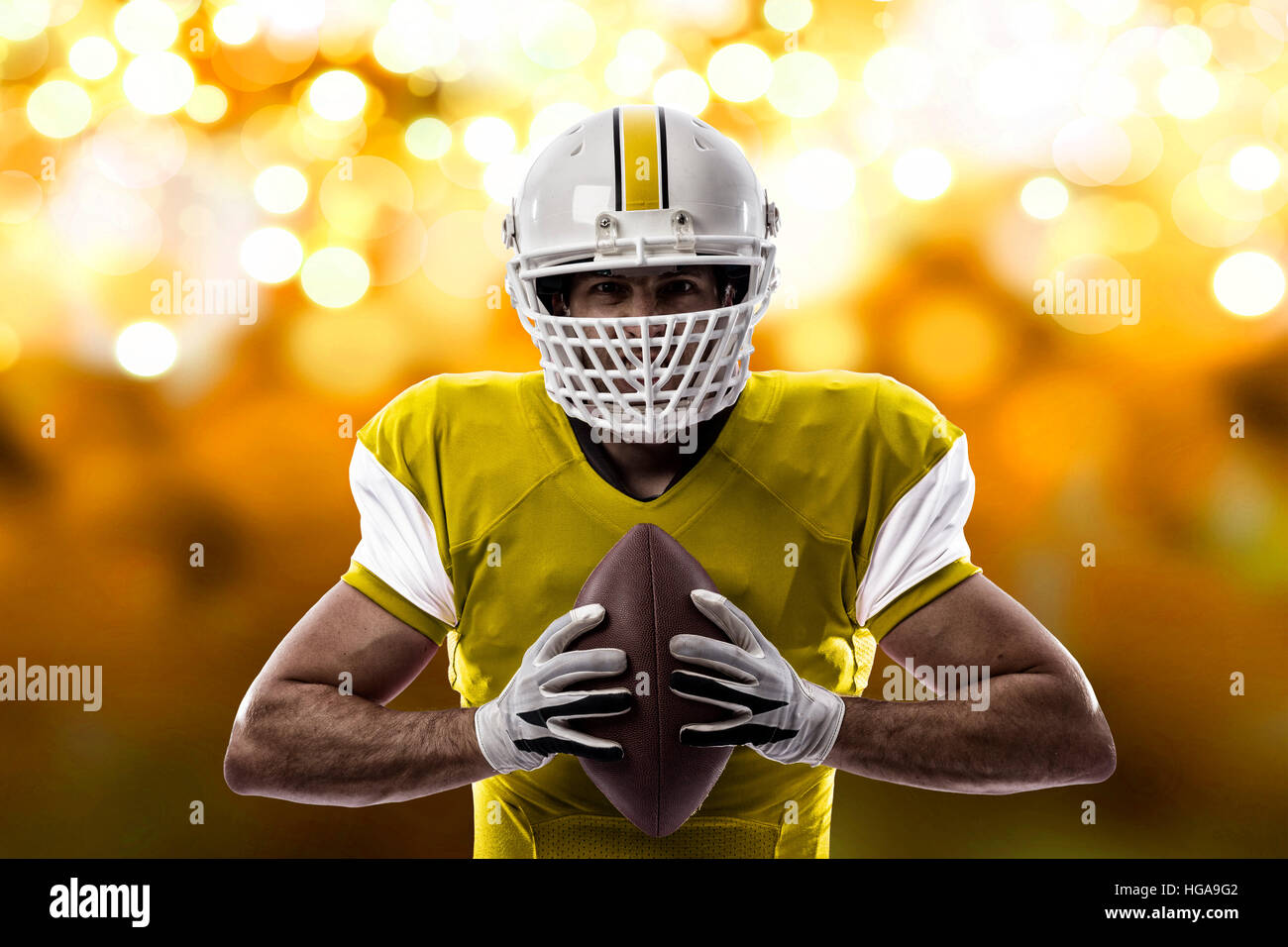 Football Player with a yellow uniform on a yellow lights background ...