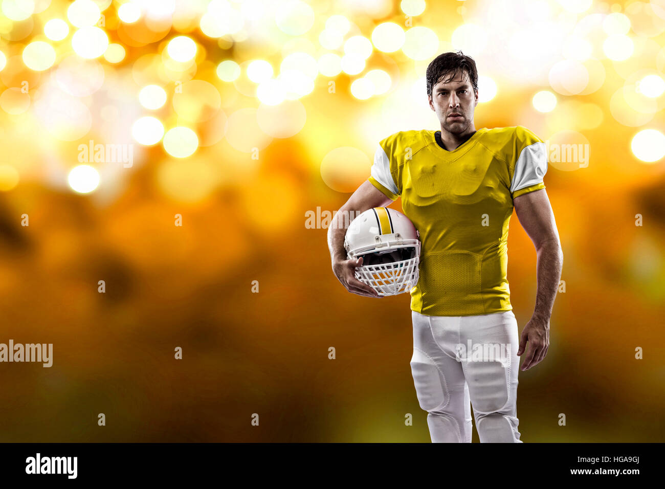 Football Player with a yellow uniform on a yellow lights background ...
