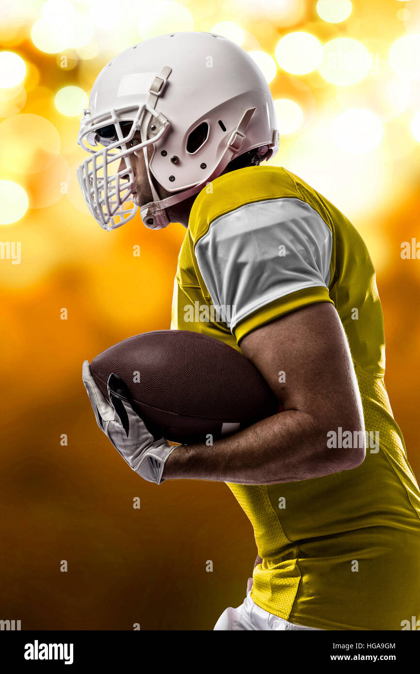 Football Player with a yellow uniform Running on a yellow lights ...