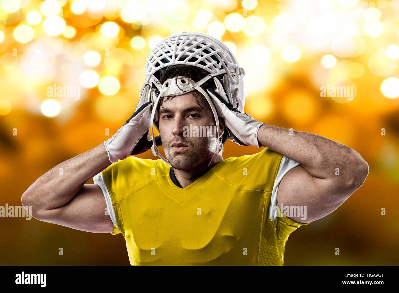 Football Player with a yellow uniform on a yellow lights background ...