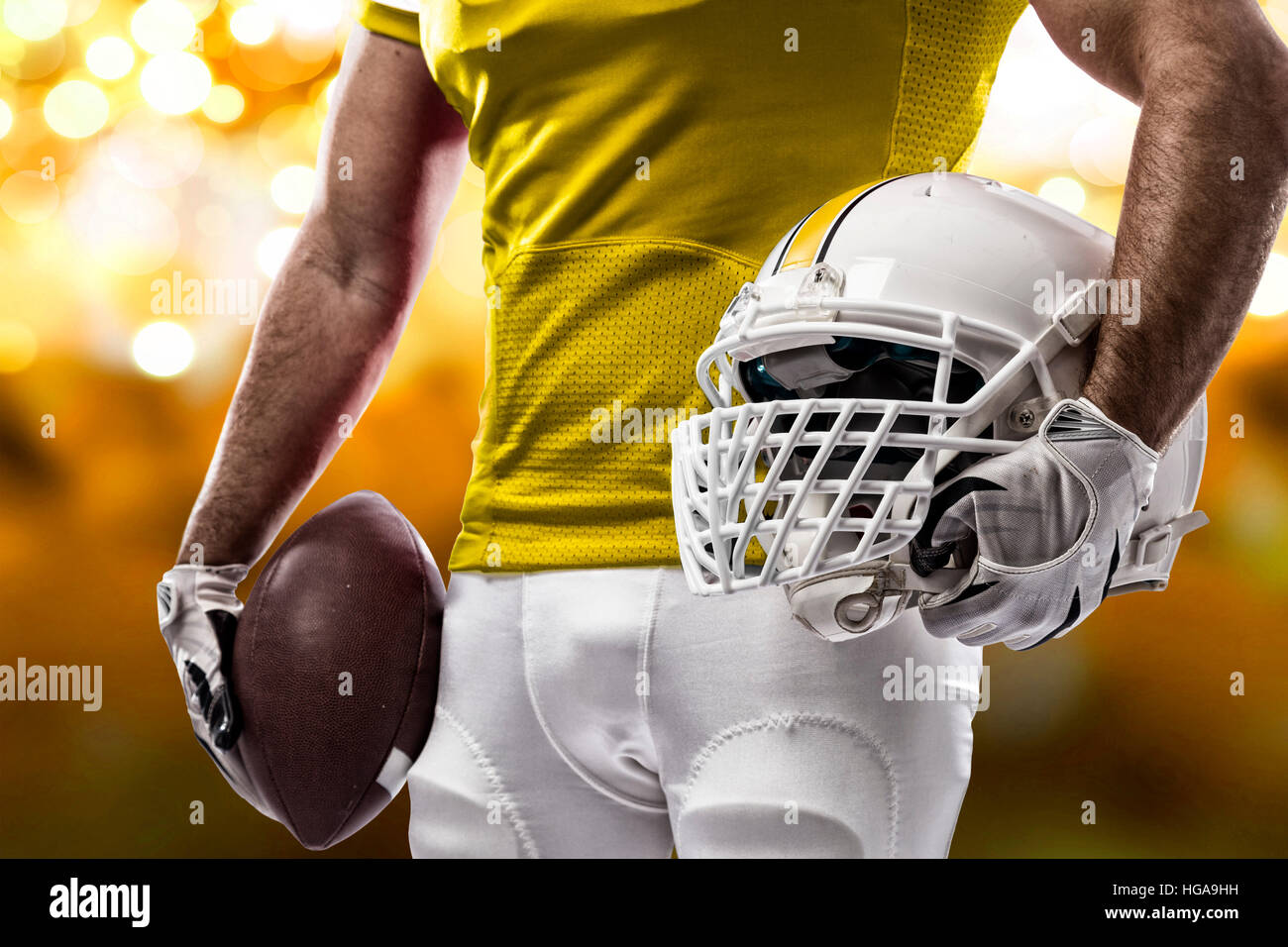 Football Player with a yellow uniform on a yellow lights background ...