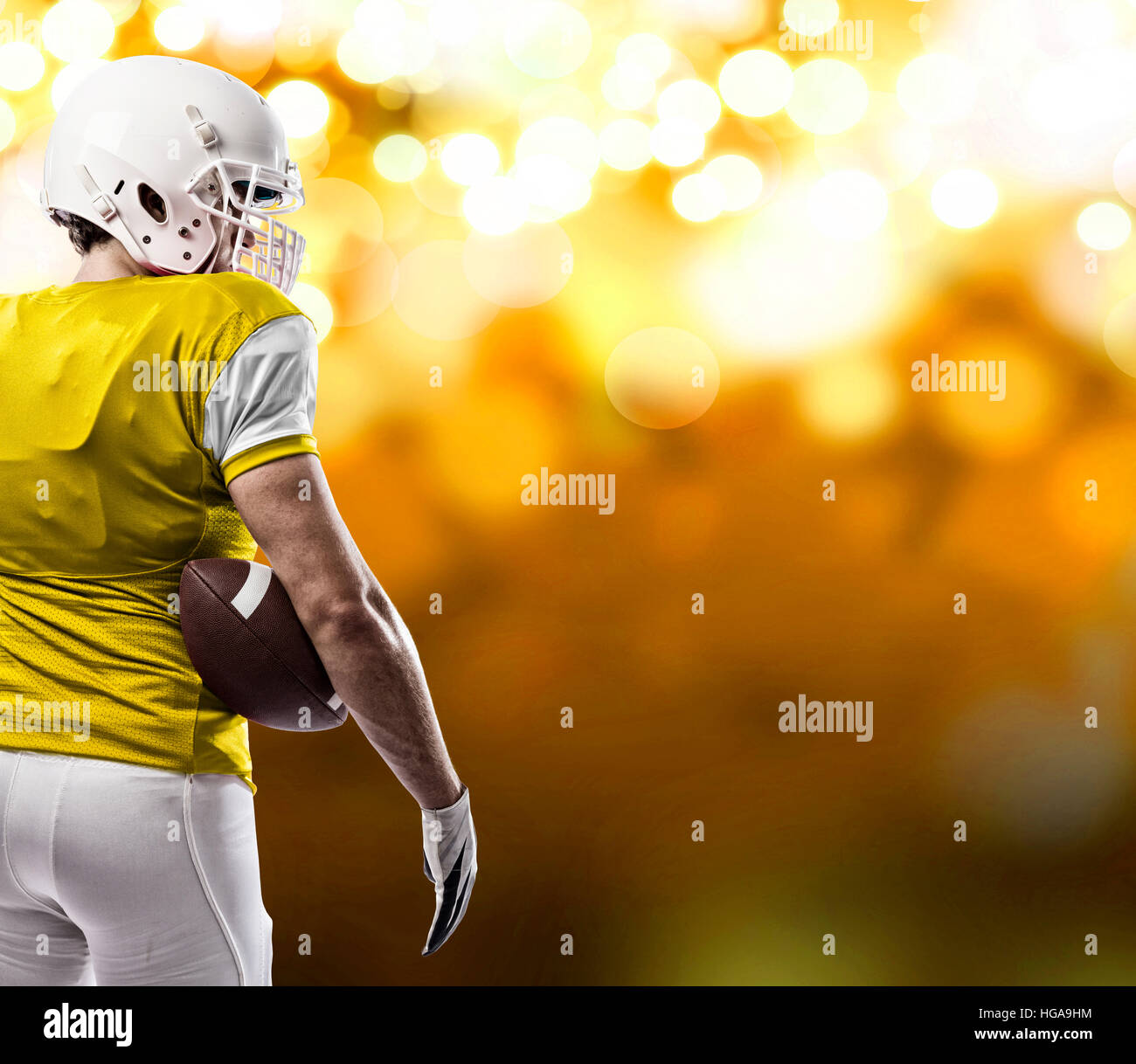 Football Player with a yellow uniform on a yellow lights background ...