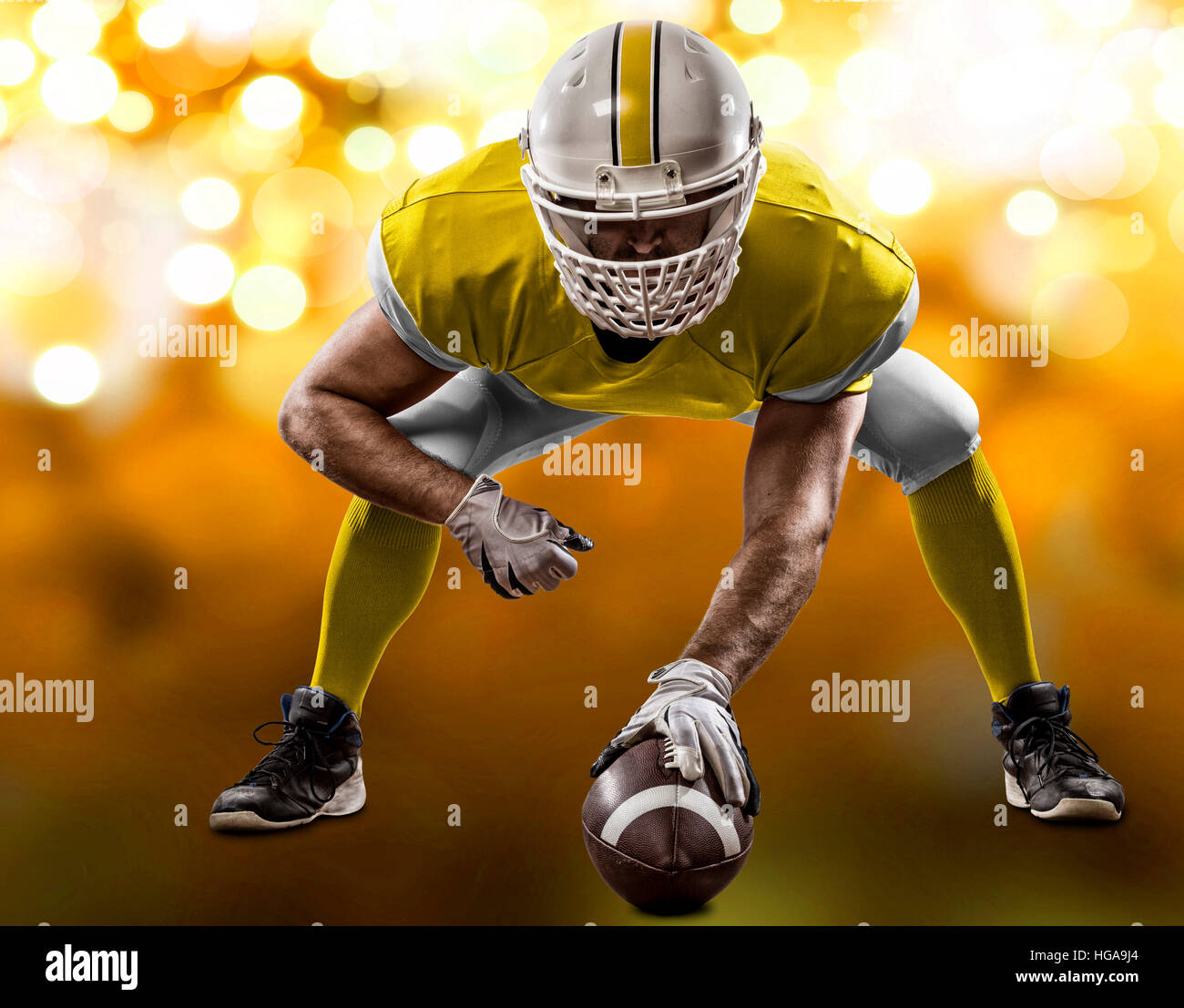 Football Player with a yellow uniform on the scrimmage line, on a ...