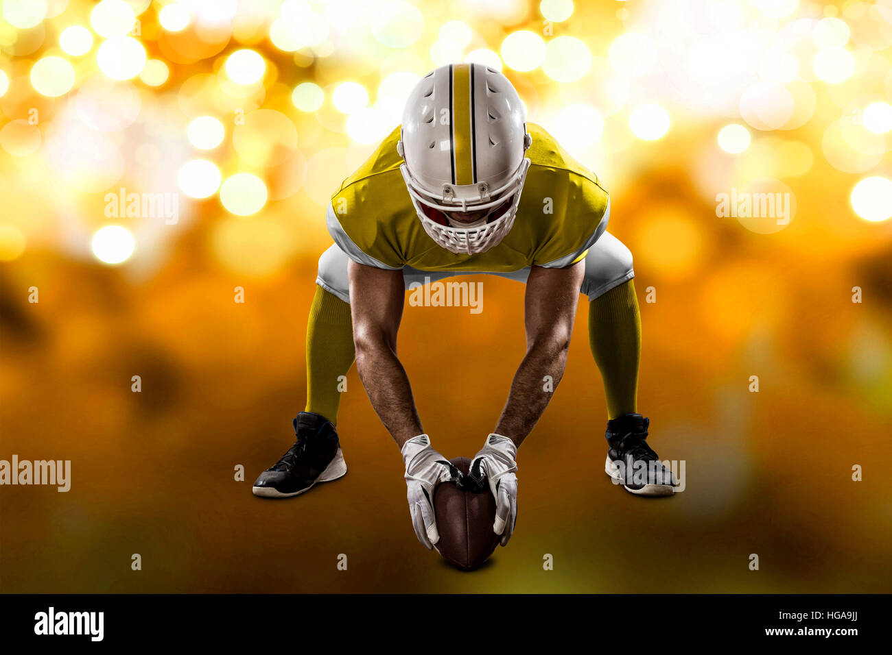 Football Player with a yellow uniform on the scrimmage line, on a ...