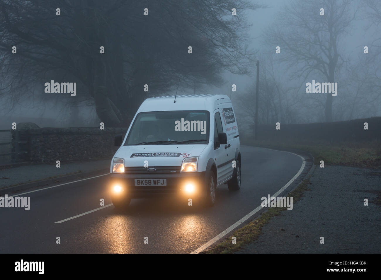 A vehicle driving through morning fog Stock Photo - Alamy