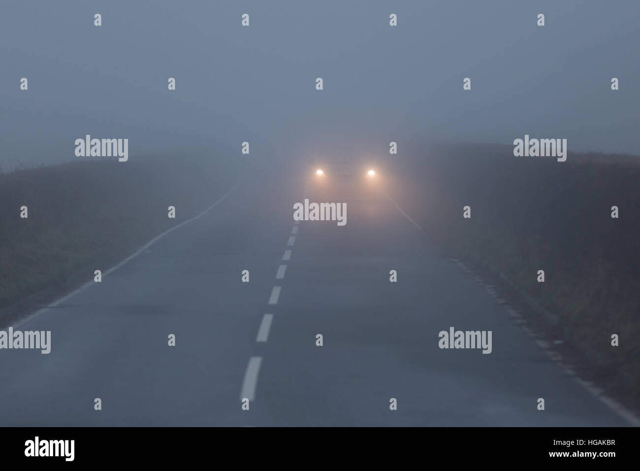 A vehicle driving through morning fog Stock Photo - Alamy