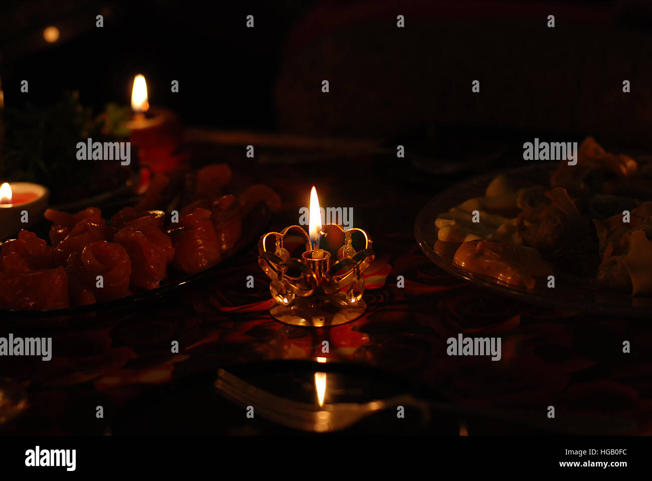 candle and red fish on the table Stock Photo - Alamy
