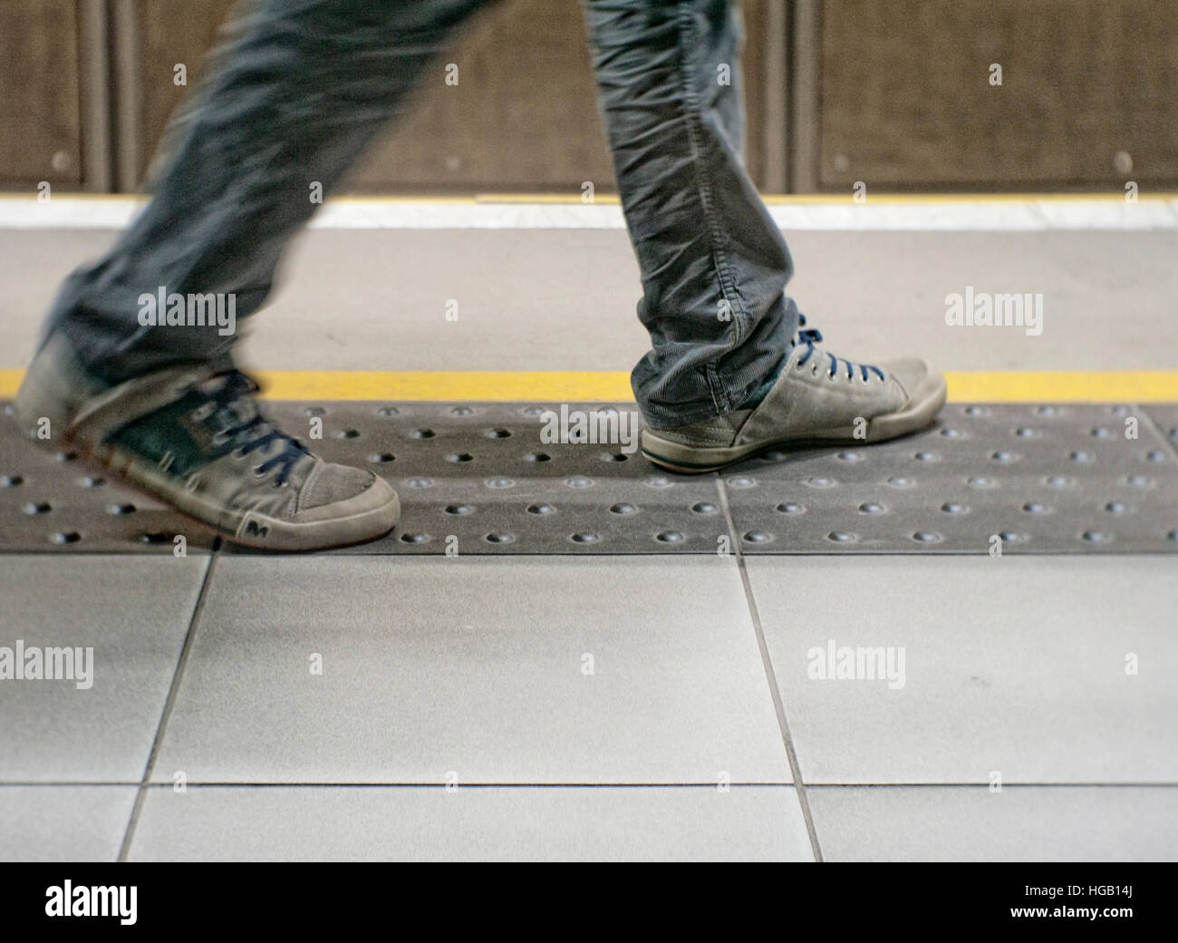 Feet in sneakers on a London Underground platform Stock Photo - Alamy