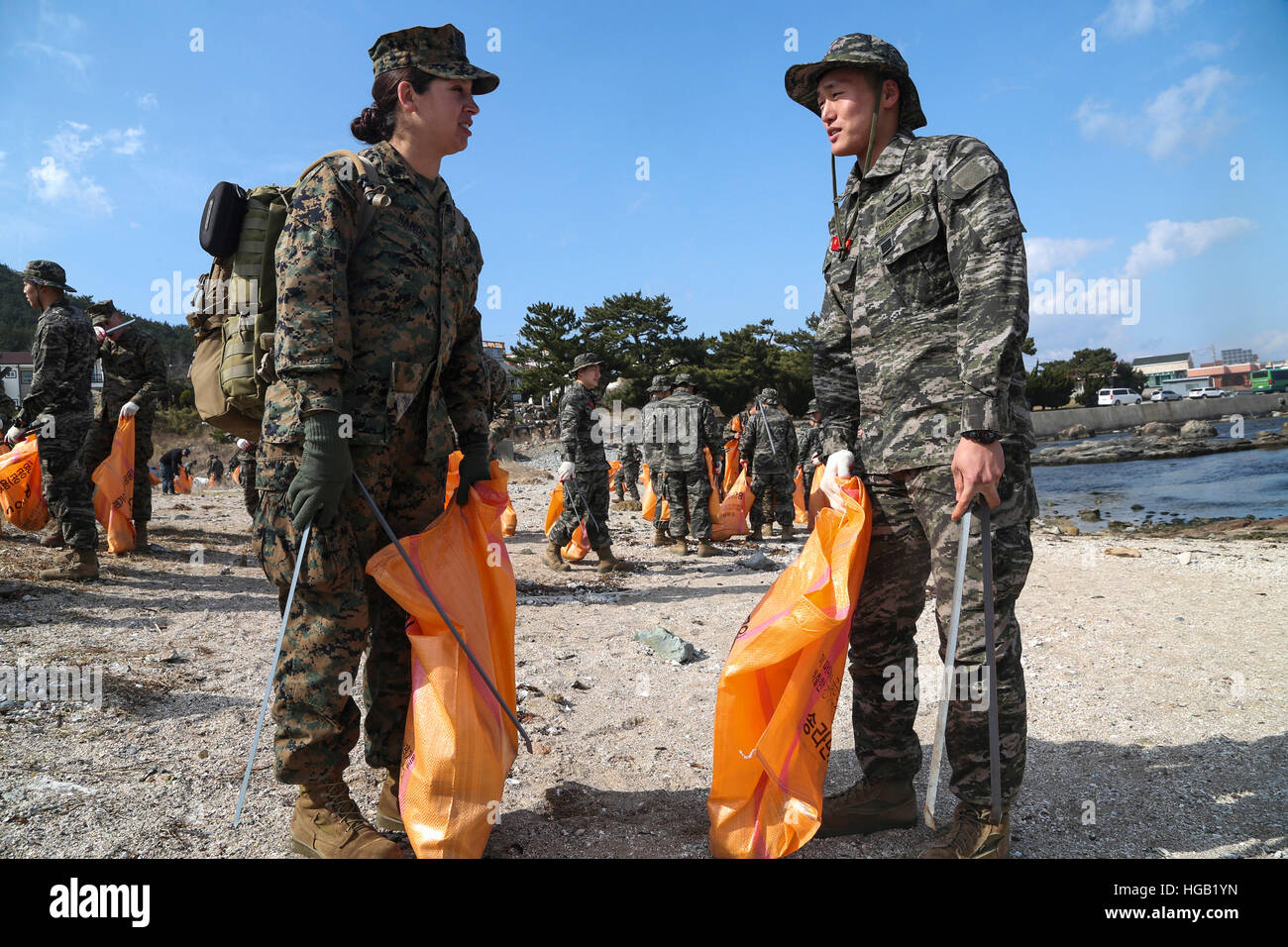 U.S. and South Korea Marines and Sailors clean a local beach in Pohang ...