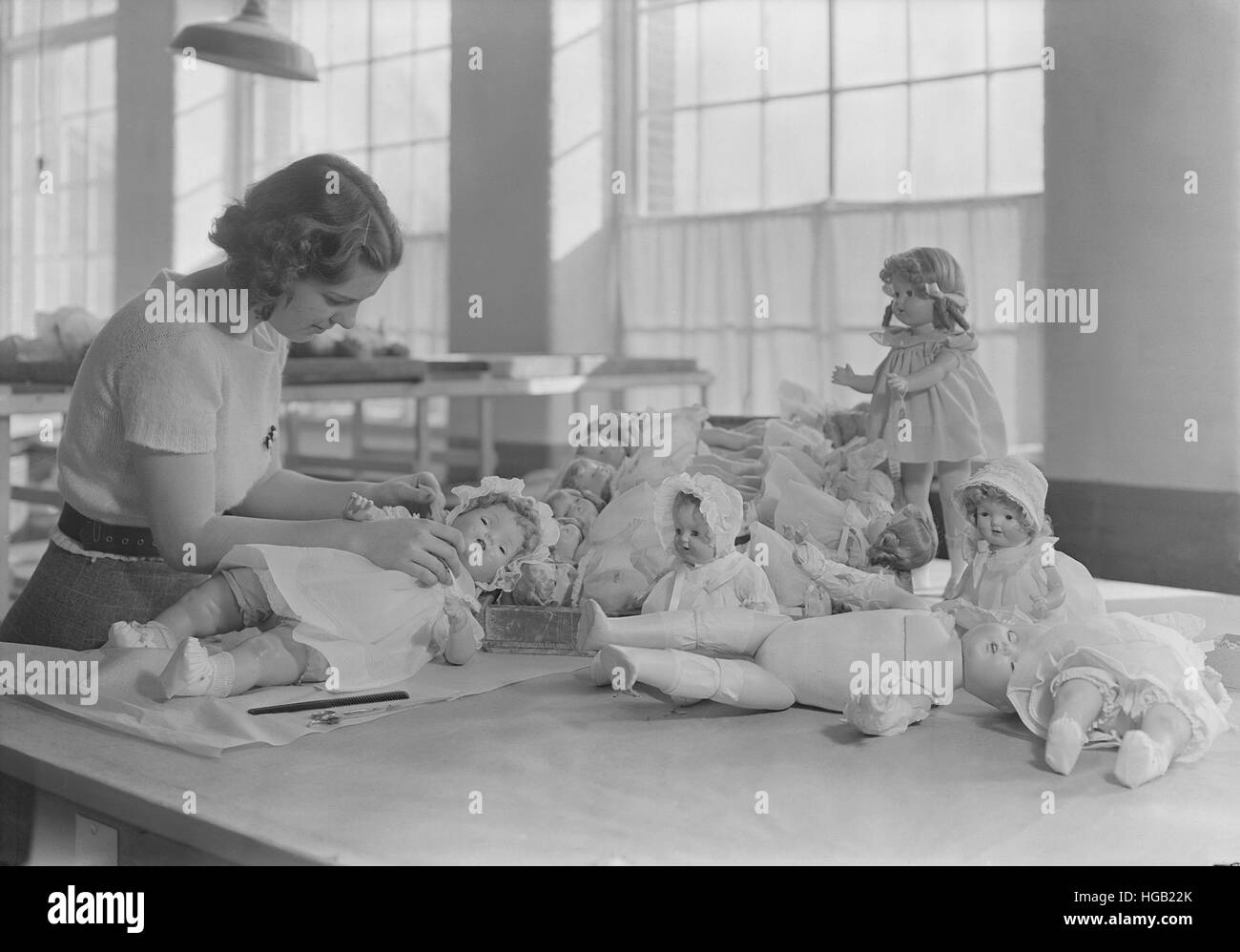 Woman dressing and packing dolls, 1936 Stock Photo - Alamy