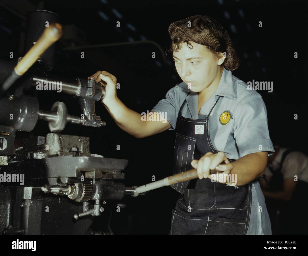 Woman working a hand mill as she makes parts for transport planes Stock ...