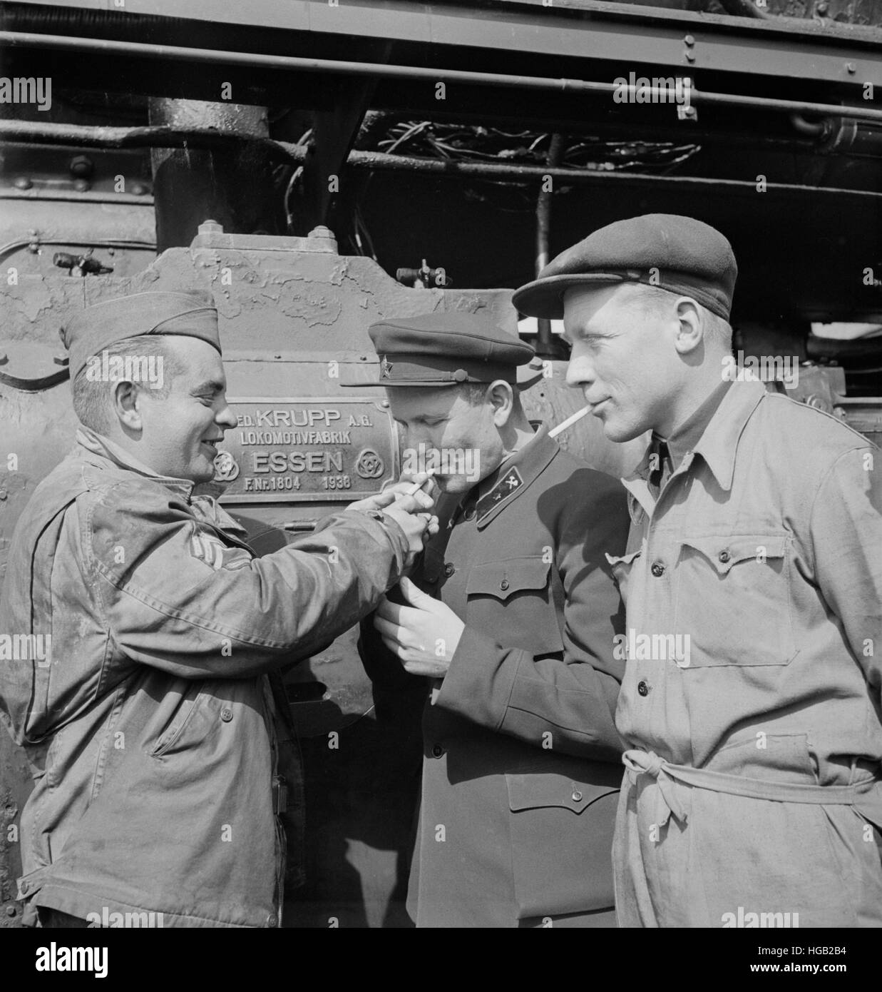 An American Sergeant railroader lighting the cigarette of two Russian ...