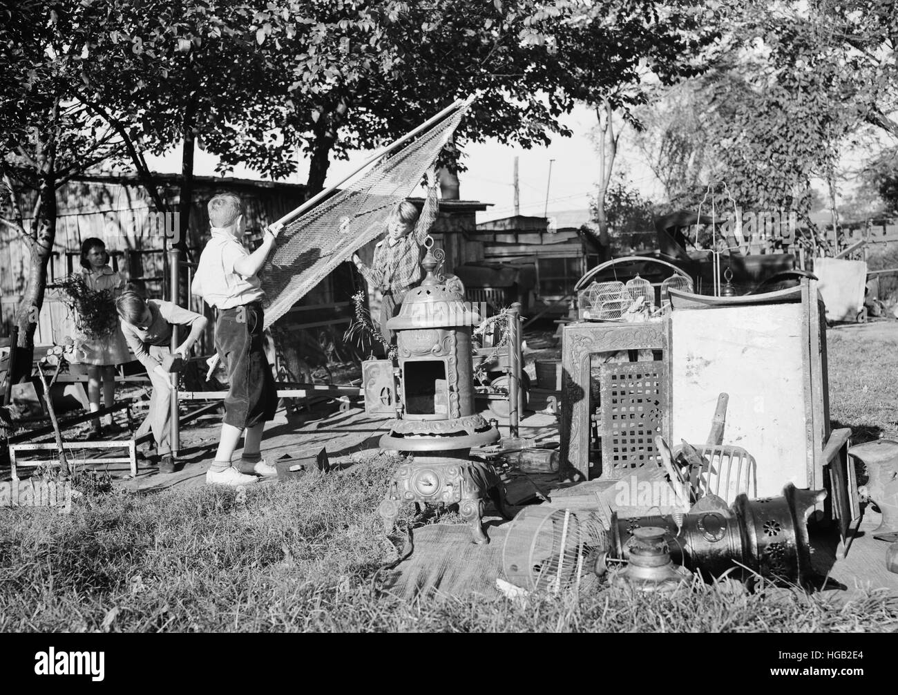 Young children collecting scrap for donation to their war industries ...