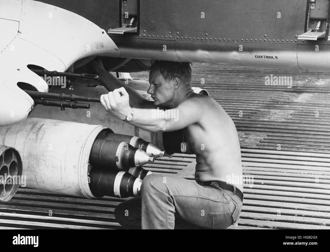 Aviation Machinist Mate drains a fuel sample from an OV-10A Bronco ...
