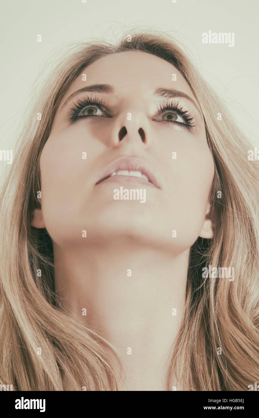 Beautiful blond woman looking up Stock Photo - Alamy