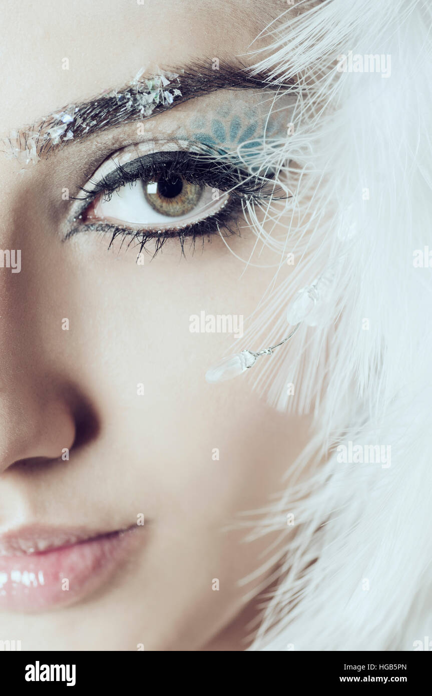 Beautiful young woman with white feather Stock Photo - Alamy