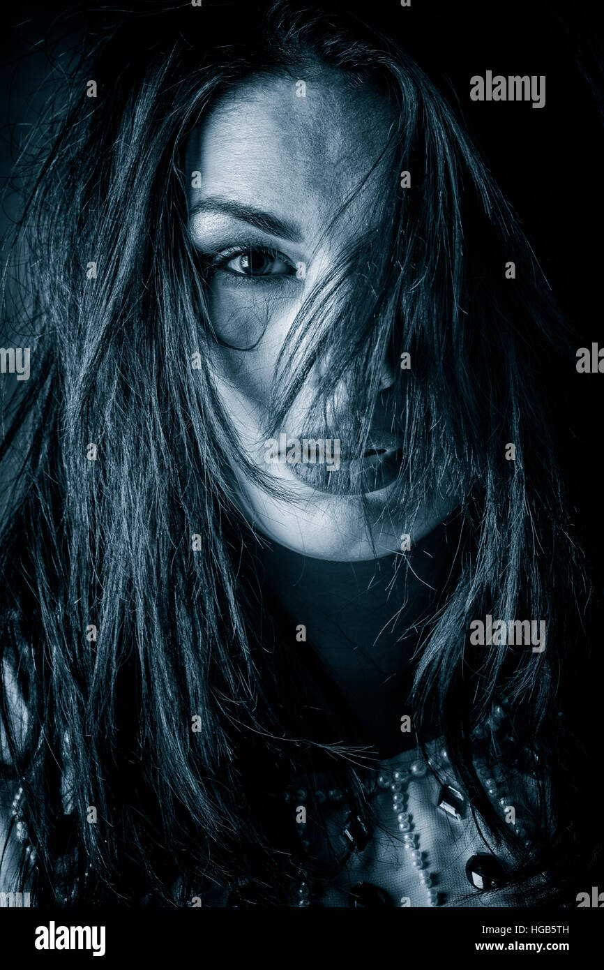Scared woman hair covering face Stock Photo - Alamy