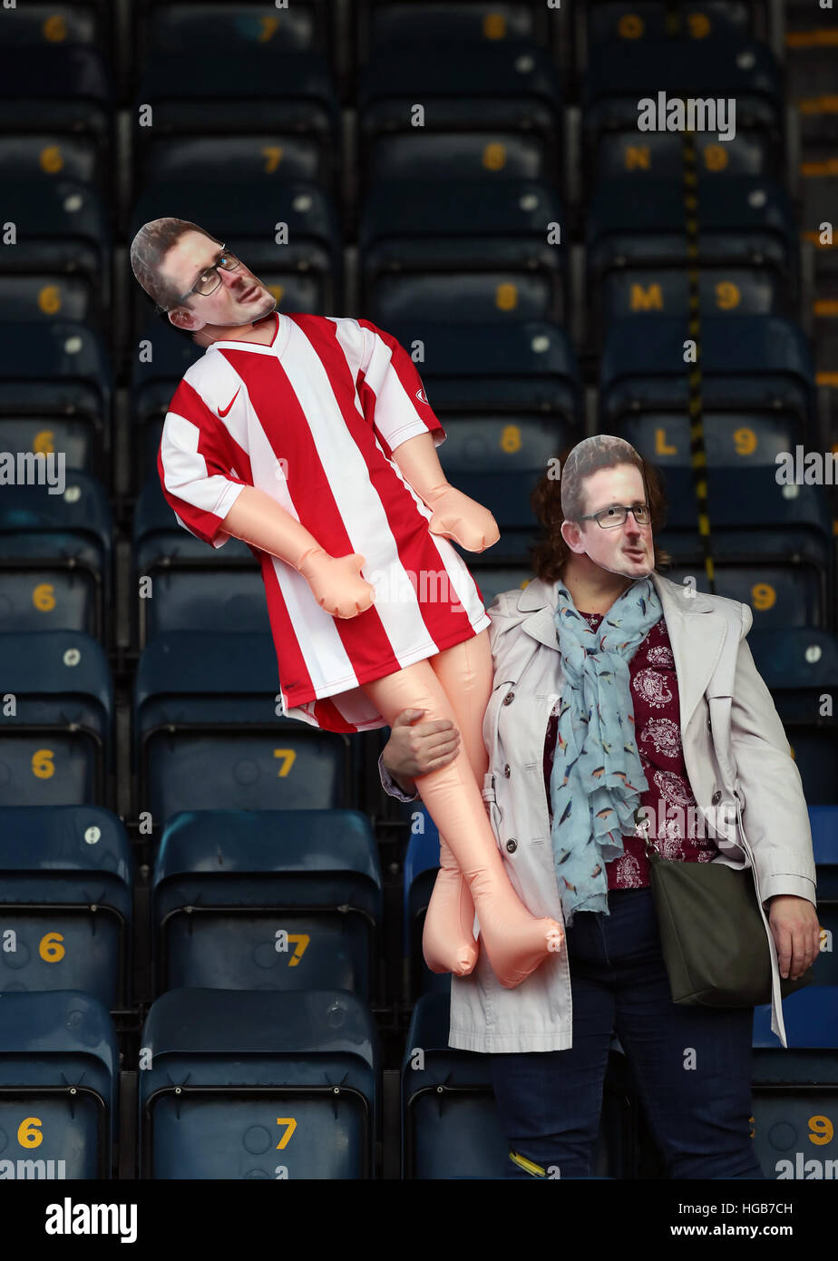 A Stourbridge fan holds up a doll of manager Gary Hackett during the ...