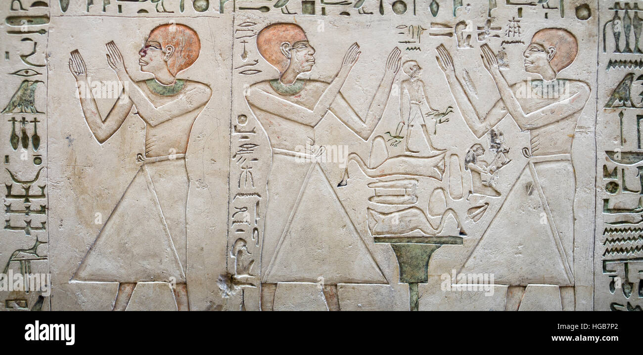 Egyptian clapping relief. A carved and painted stone relief of three ...