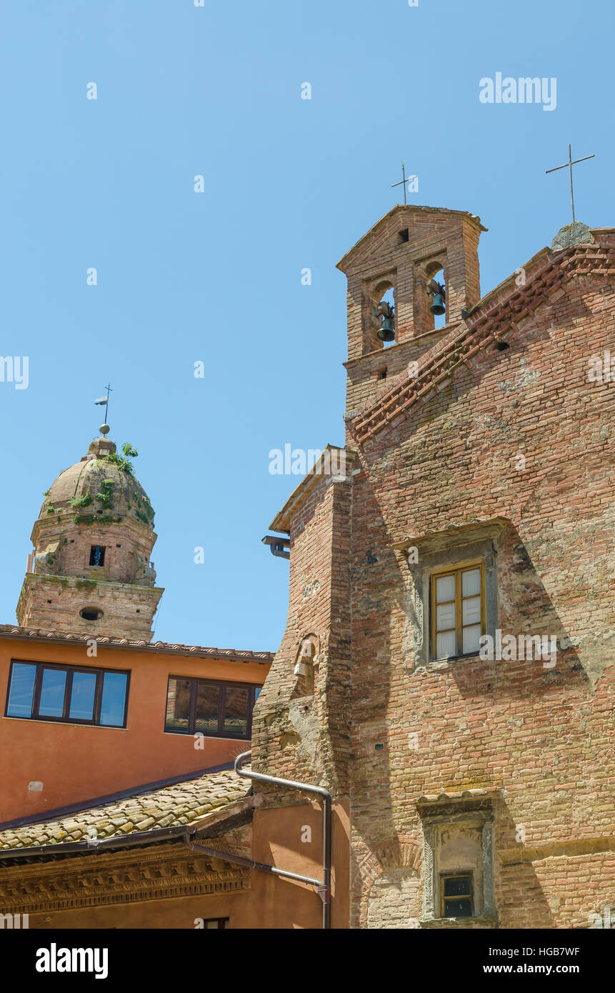 Two historic brick churches with towers in contrast to more modern ...