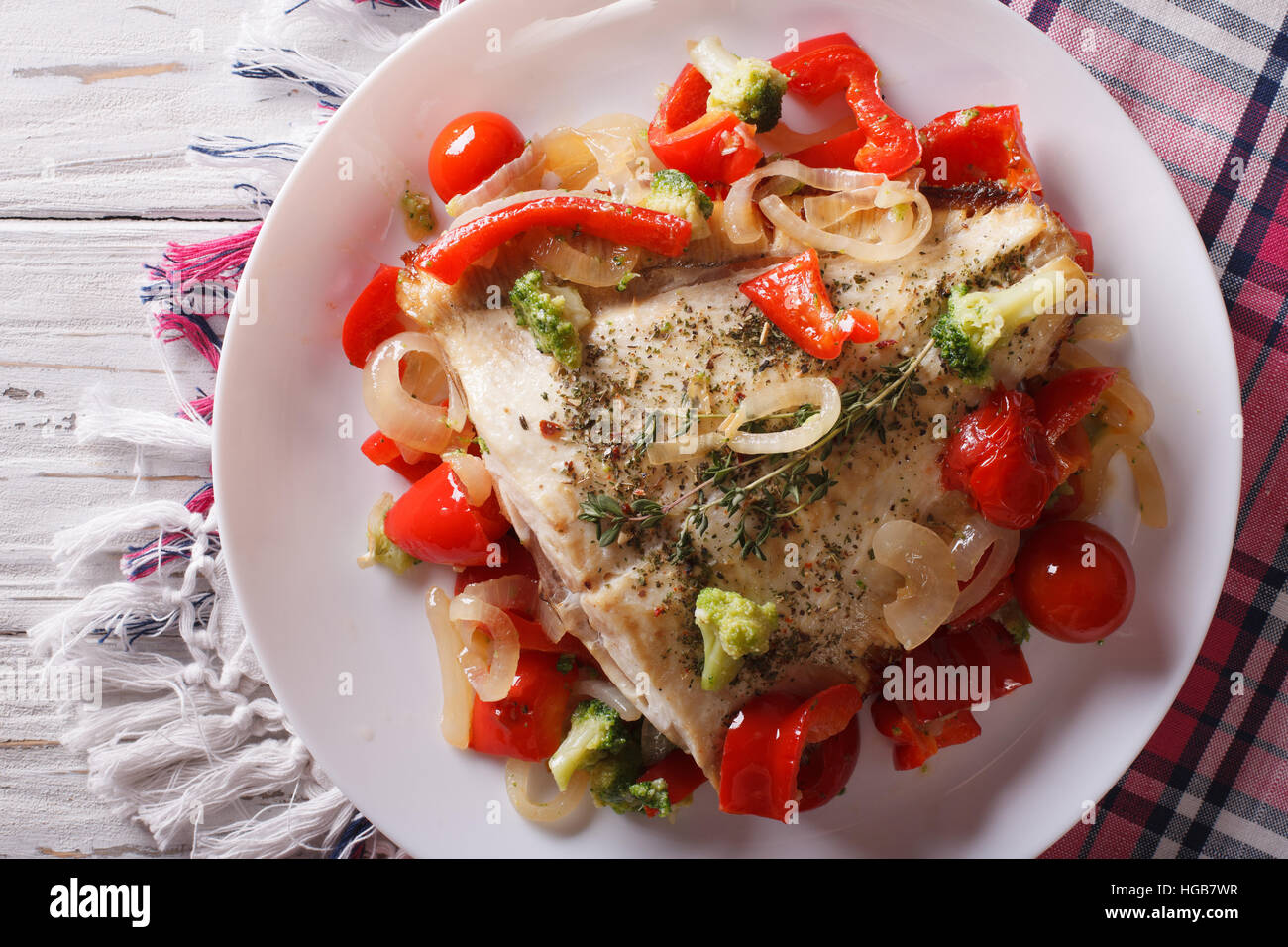 Delicious baked flounder with seasonal vegetables close-up on a plate ...