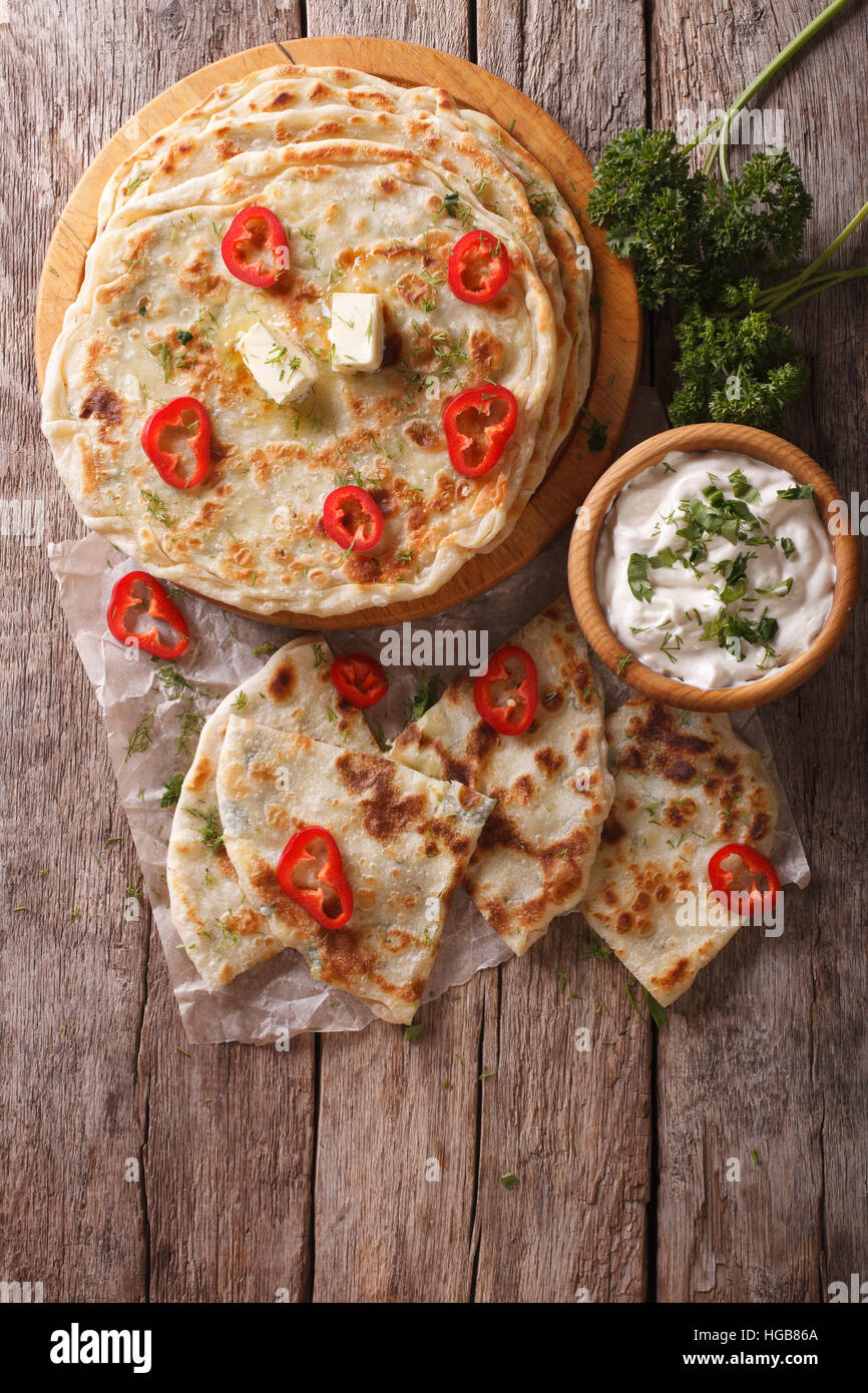 Indian paratha stuffed with potatoes on the table. vertical top view ...
