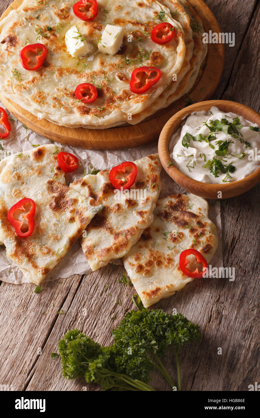 Indian paratha stuffed with potatoes and sauce close-up on the table ...