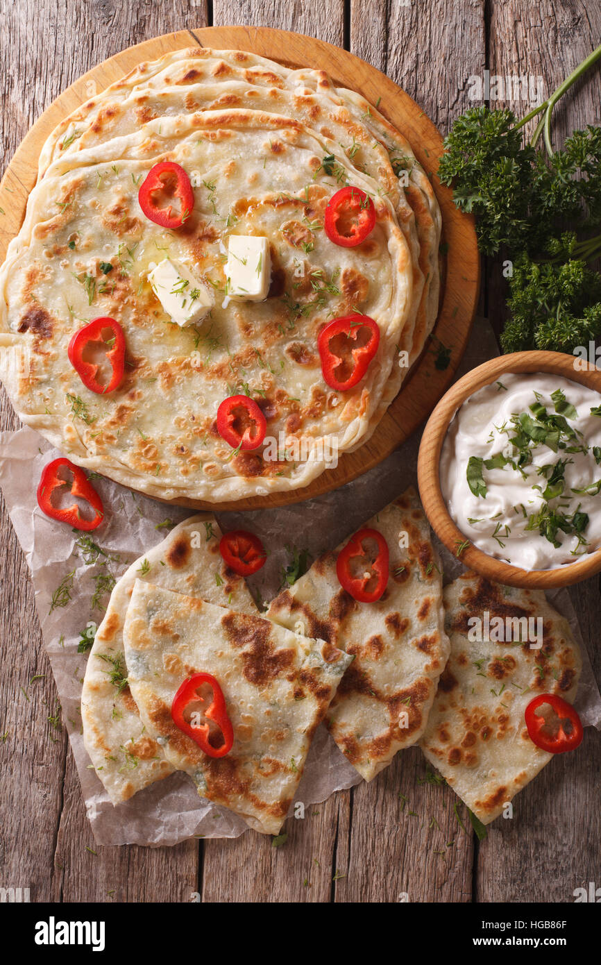 Indian paratha stuffed with potatoes close up on the table. vertical ...